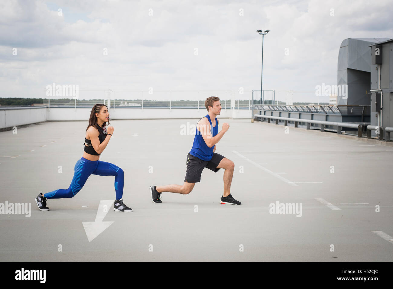 Man and woman doing lunges outdoor Stock Photo - Alamy