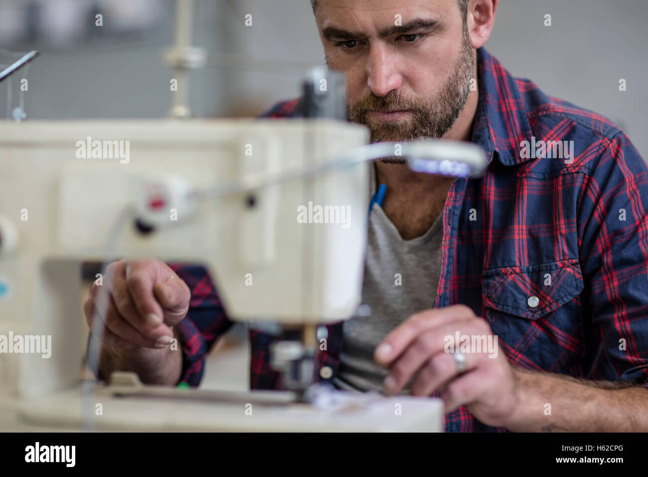 Tailor working on sewing machine Stock Photo - Alamy
