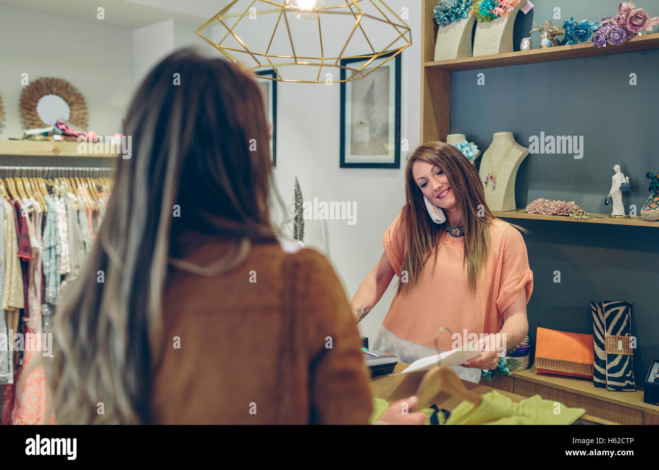 Female shop assistant counter fashion hi-res stock photography and ...