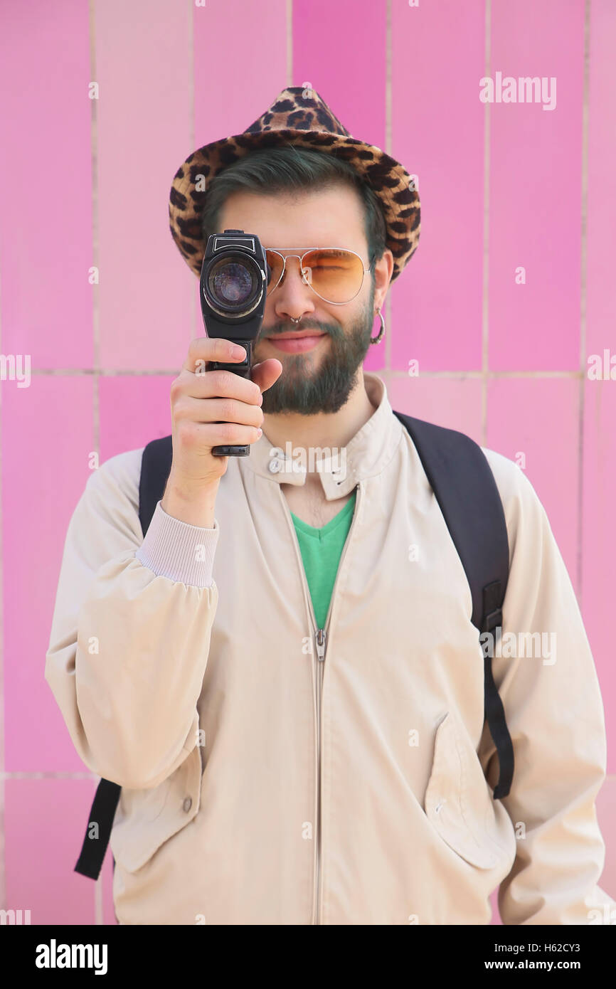Young man using a vintage video camera filming viewer Stock Photo - Alamy
