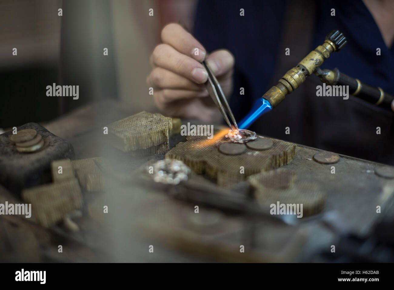Goldsmith working on jewelery in workshop Stock Photo - Alamy