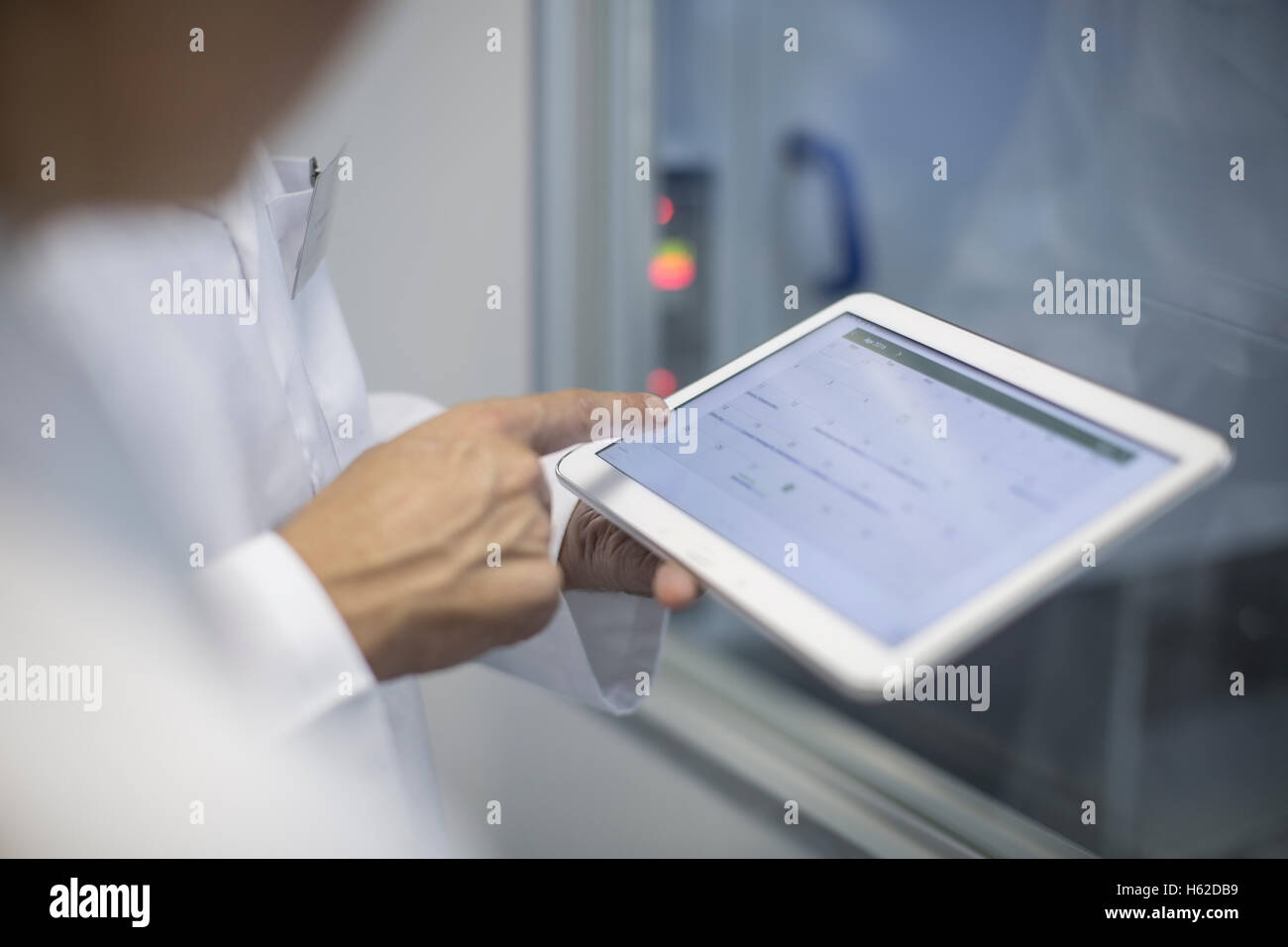 Two scientists sharing tablet Stock Photo - Alamy