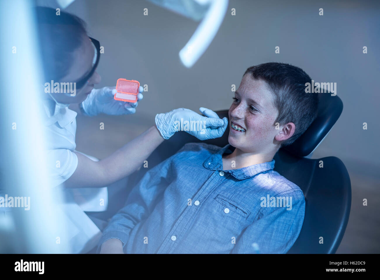 Boy in dental surgery receiving orthodontic treatment Stock Photo - Alamy