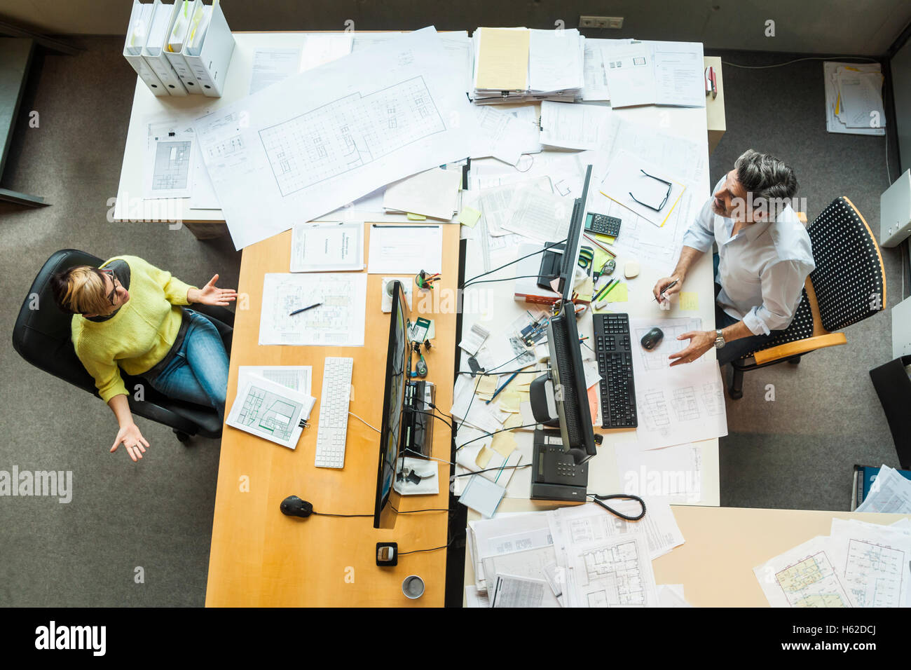 Male and female architects working in office, view from above Stock ...