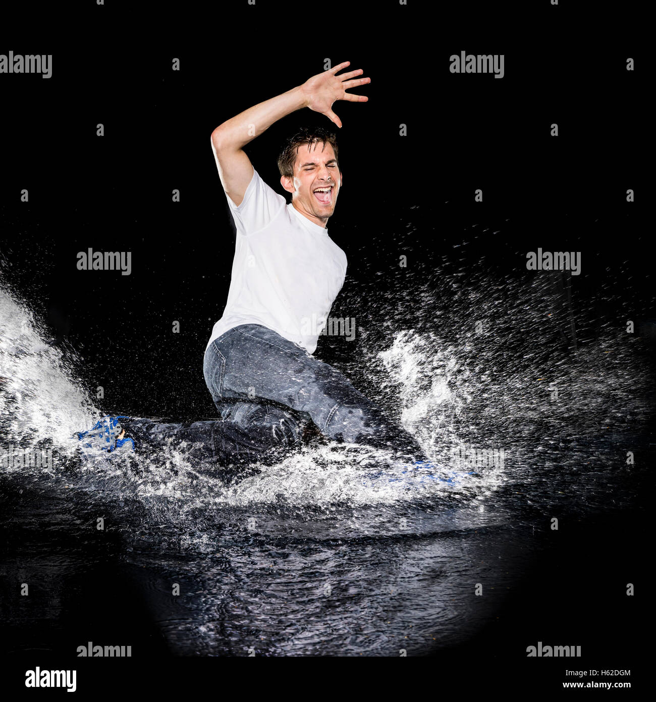 Man jumping in splashing water Stock Photo - Alamy