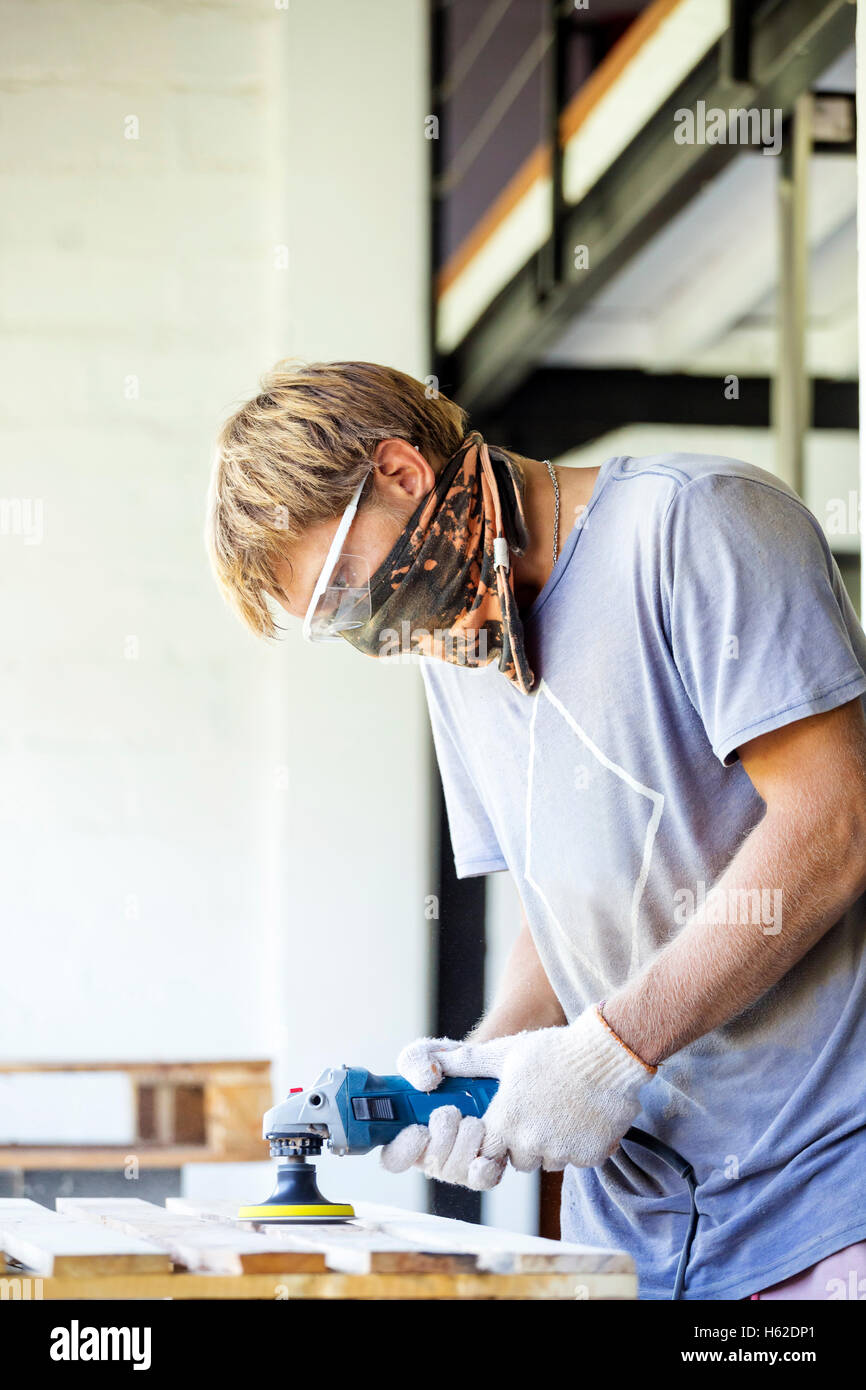 Man sanding wood with a random orbital sander Stock Photo - Alamy