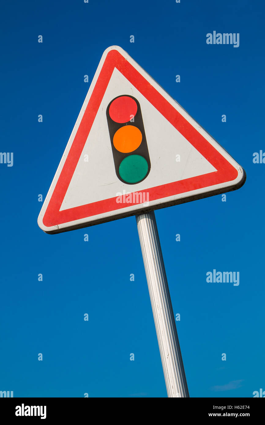 warning sign with a picture of a traffic signal on blue sky Stock Photo ...