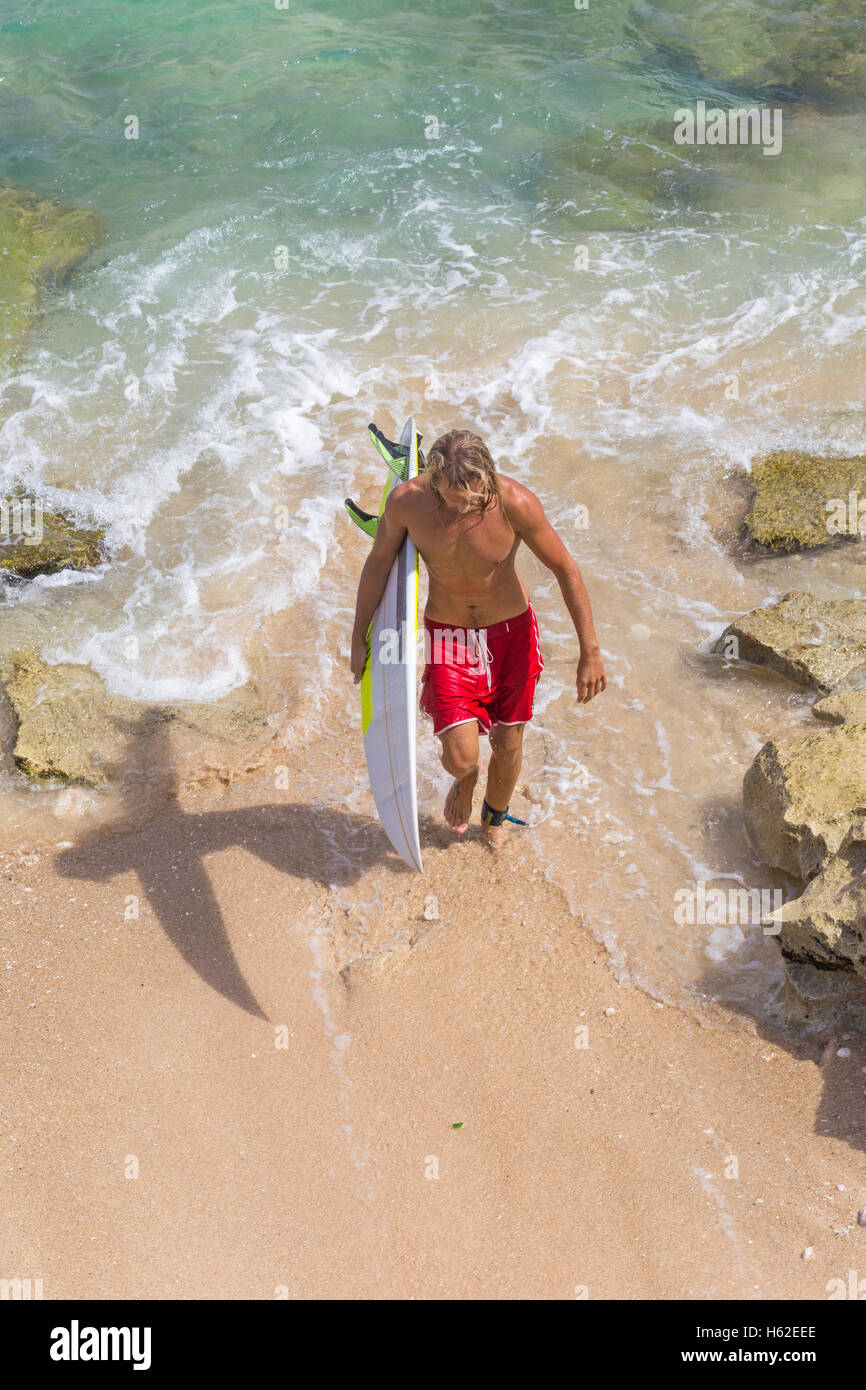 Surfer with surfboard at beach Stock Photo - Alamy