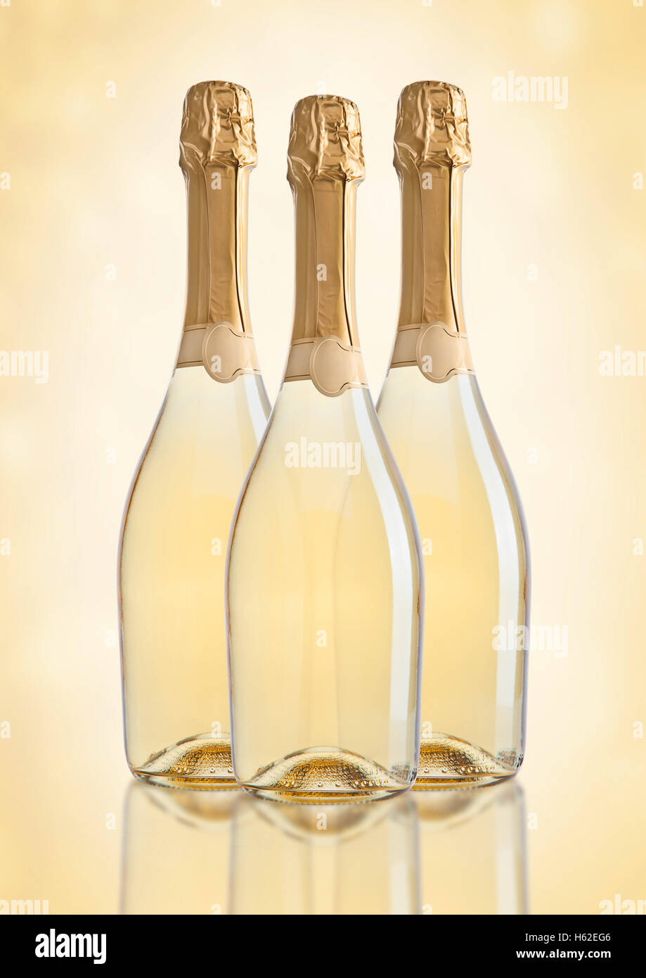 Bottles of champagne golden yellow color on golden background Stock ...
