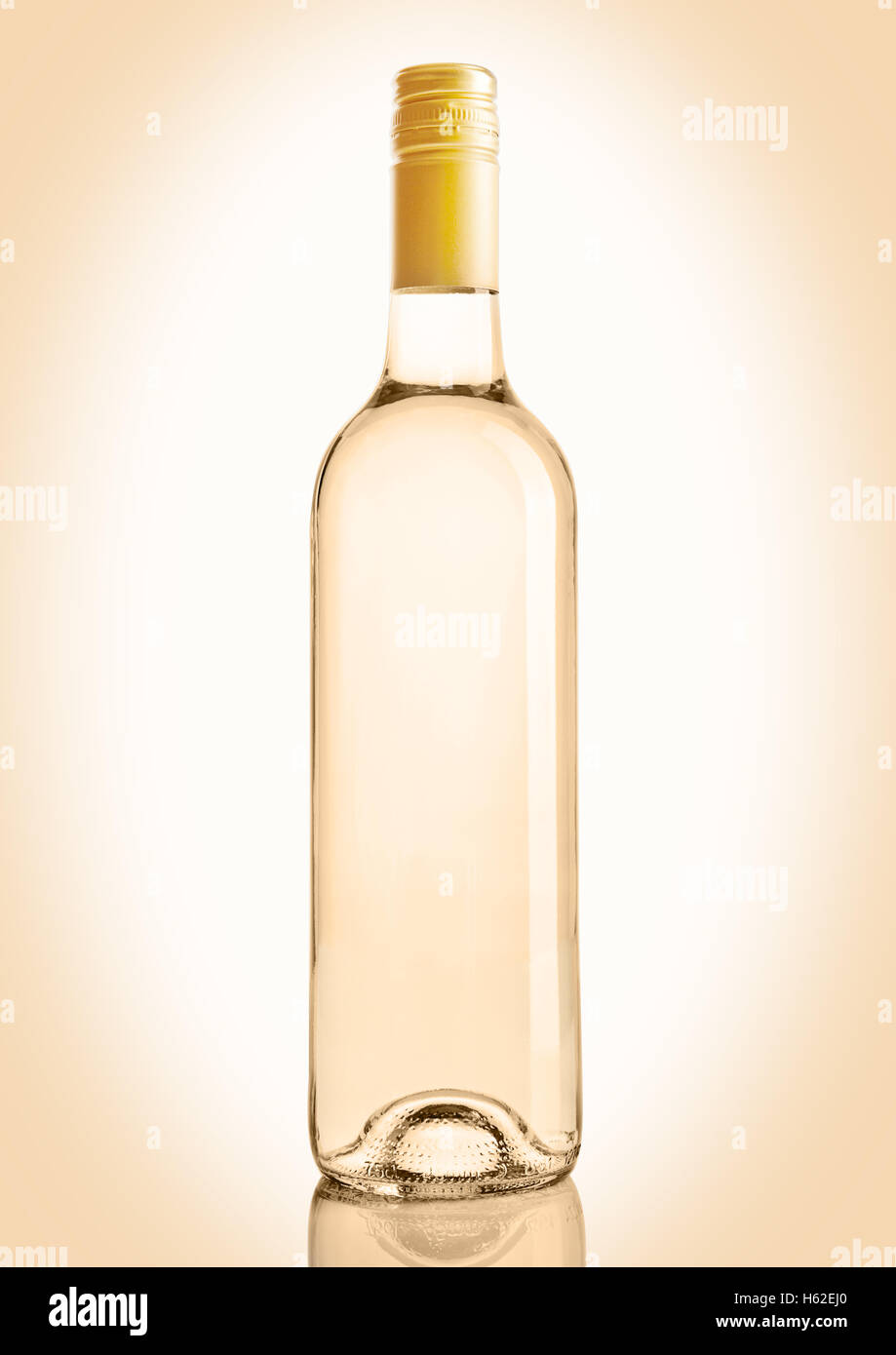 Bottle of white wine golden color on golden background Stock Photo - Alamy