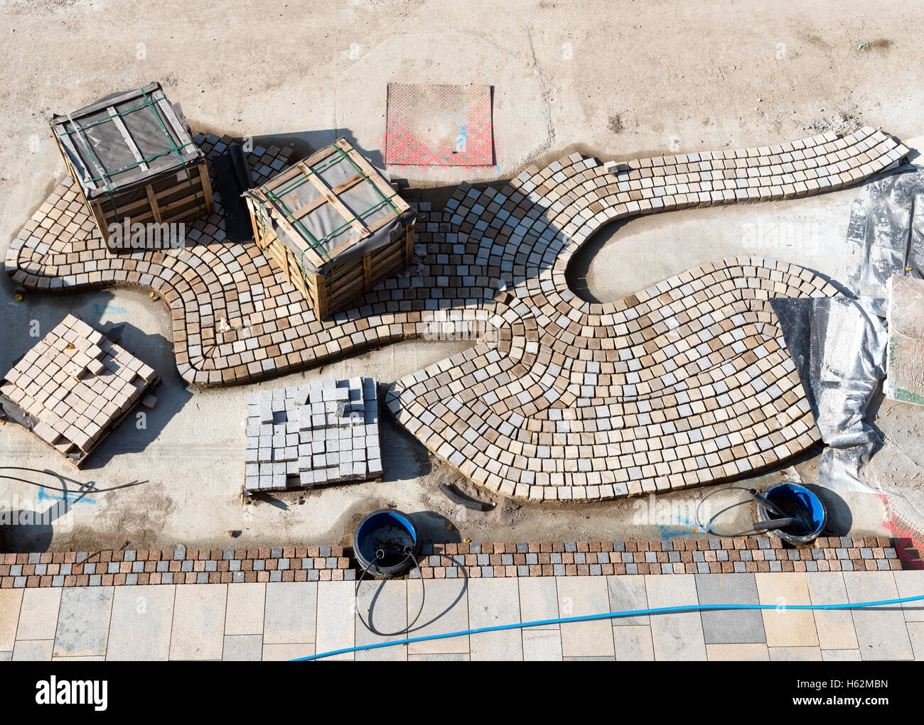 The construction of cobble paving outside the WestQuay Watermark ...