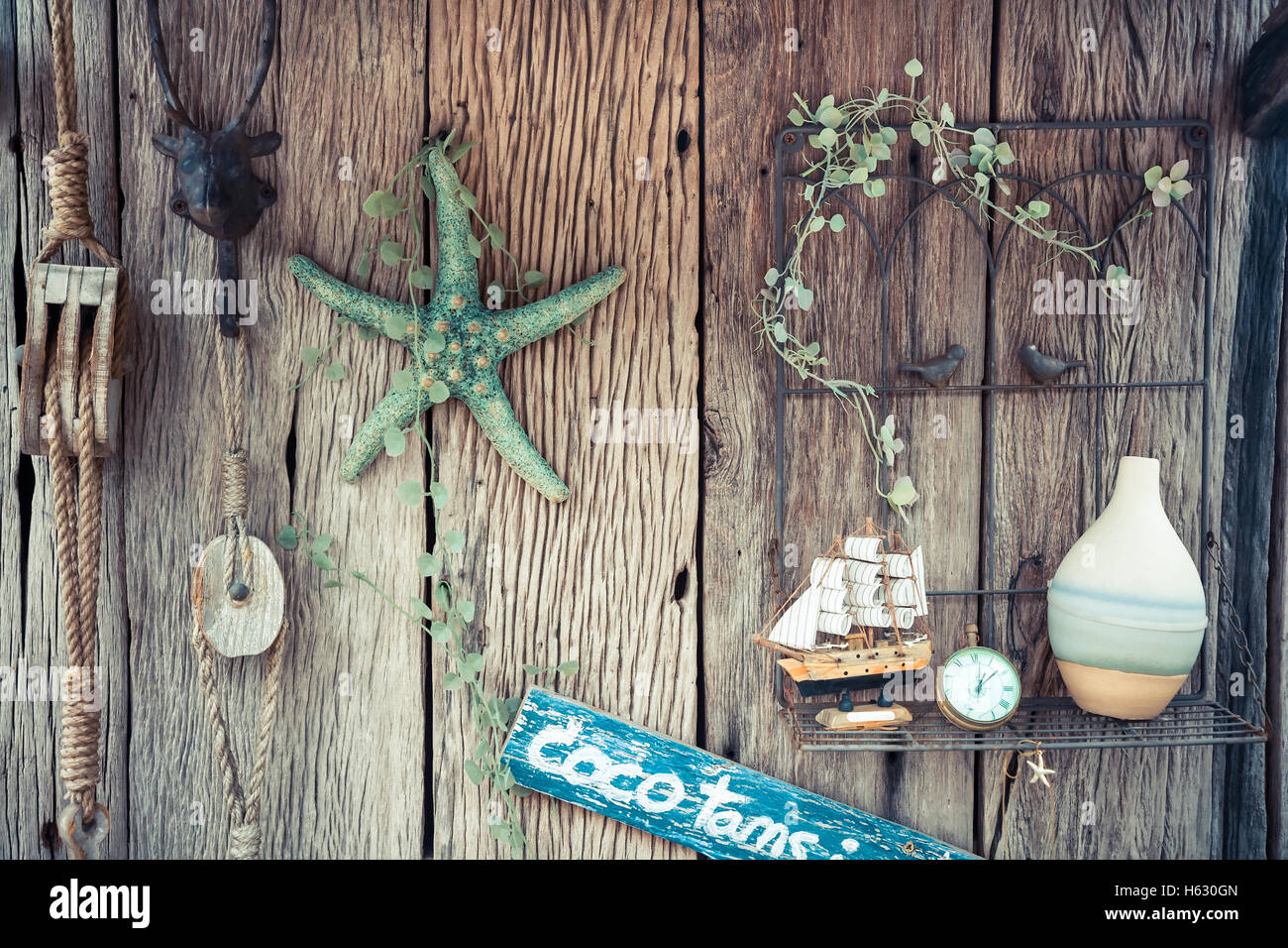 Vintage holidays still life with rope, starfish, compass and bottle on ...