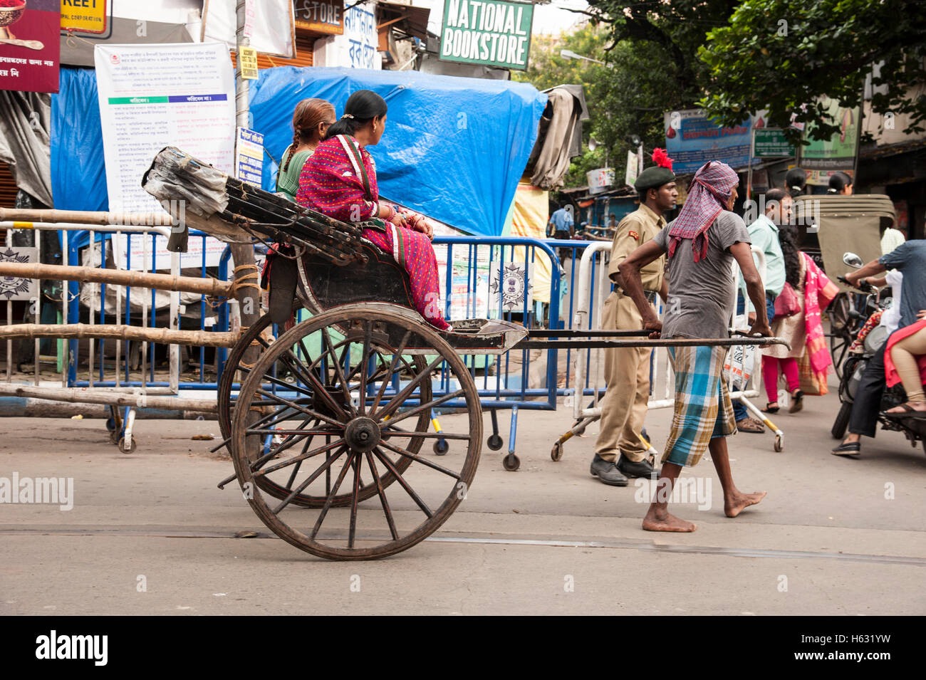 traditional hand pulled rickshaw puller pulling with passenger on ...
