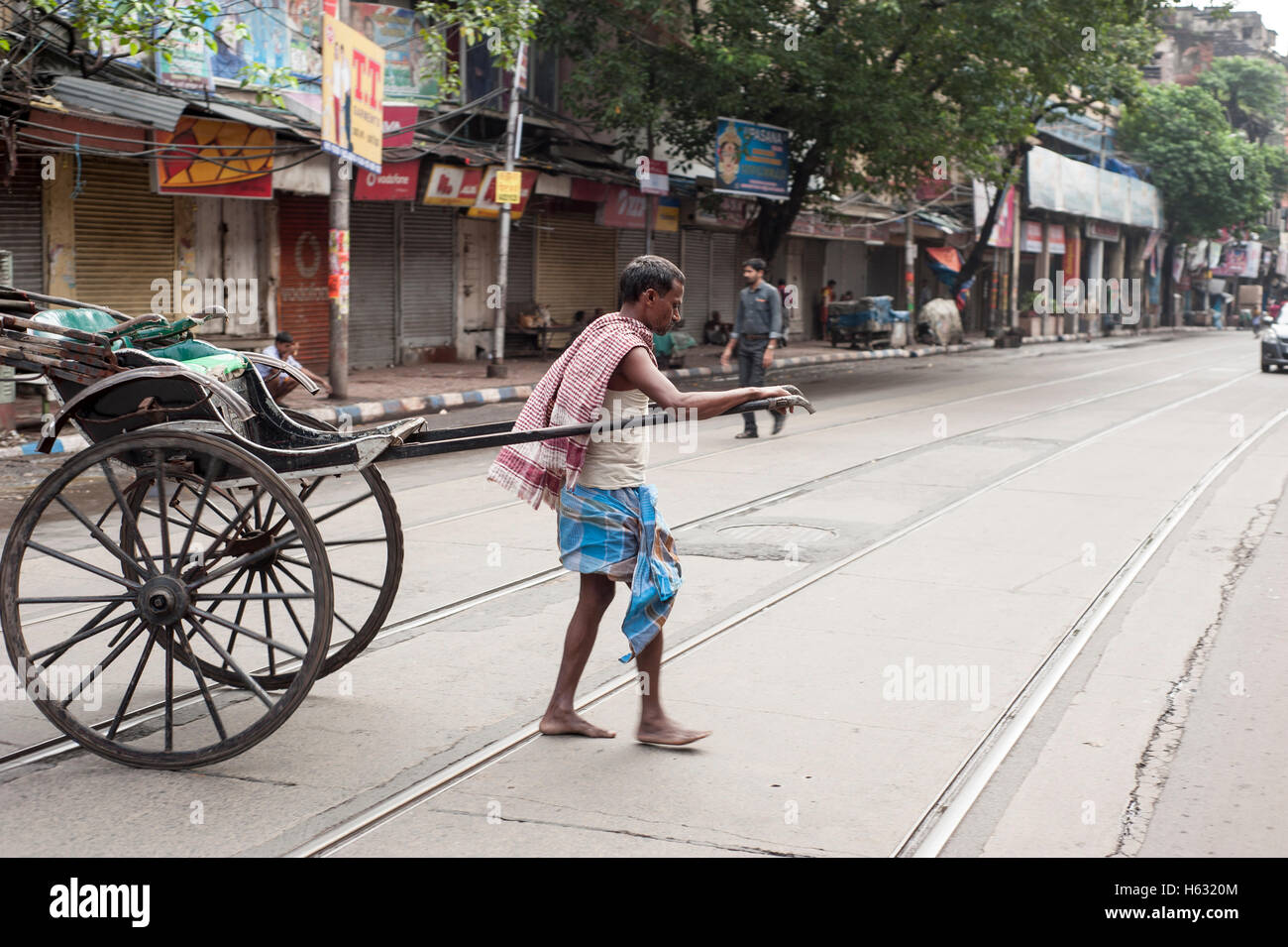 Hand Pulled Rickshaw passing on Tram line street kolkata west Bengal ...