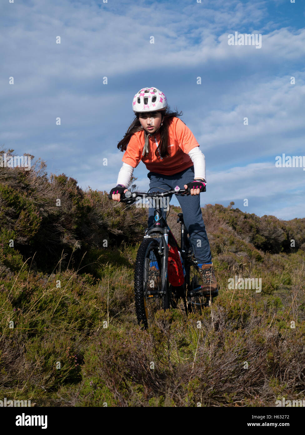 Young girl cycling off road Stock Photo - Alamy