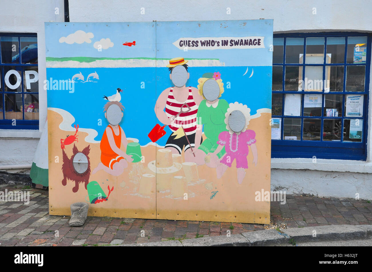 Seaside artwork putting head in hole for a picture in Swanage town ...