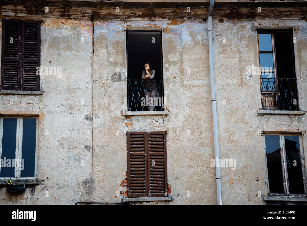 Woman watching from the window of the old house, Como, southern tip of ...