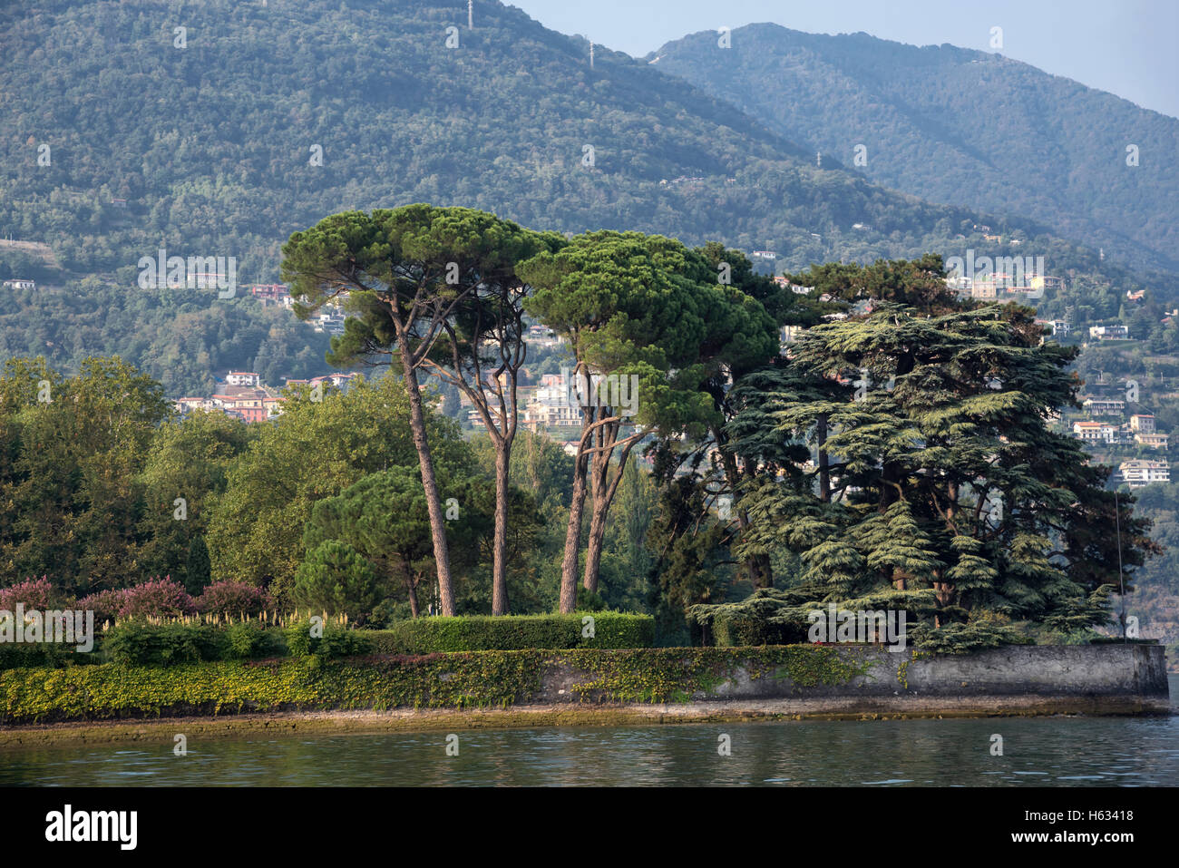 Beautiful landscape of Lake Como shore with trees and foothills of the ...