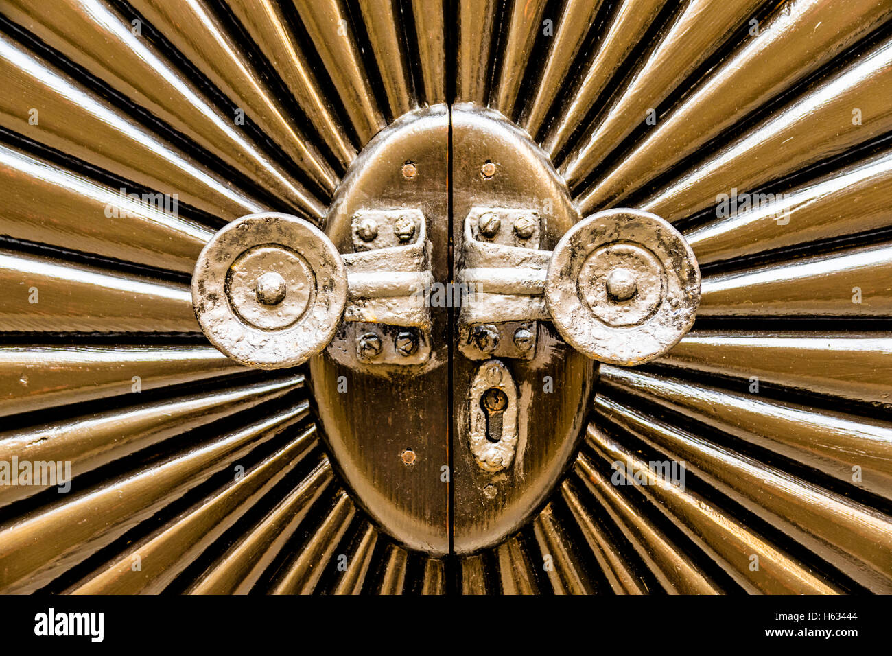 Metal door shaped sunburst with round handles Stock Photo - Alamy
