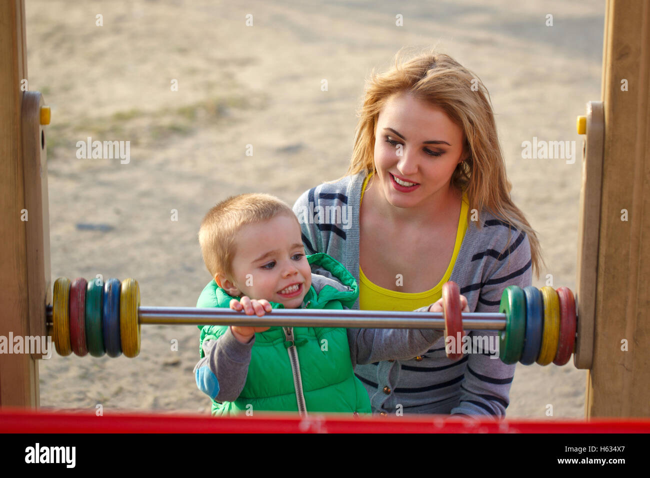 Mother and son on playground in autumn park. Family time. Happiness of ...