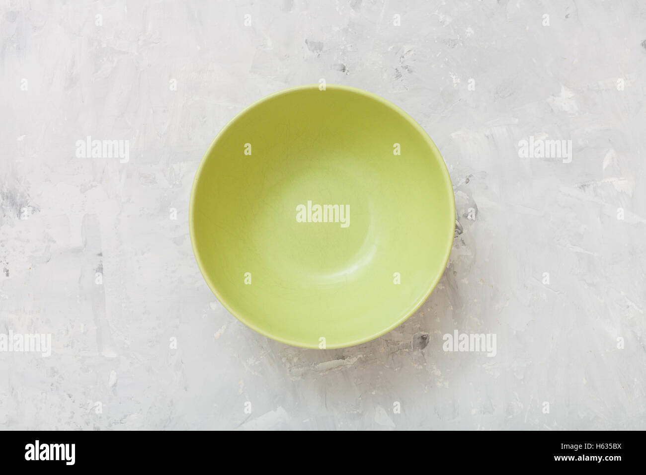 top view of green bowl on gray concrete plate Stock Photo - Alamy