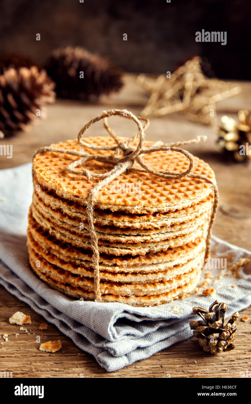 Stack of traditional dutch caramel waffles tied up with jute twine on ...