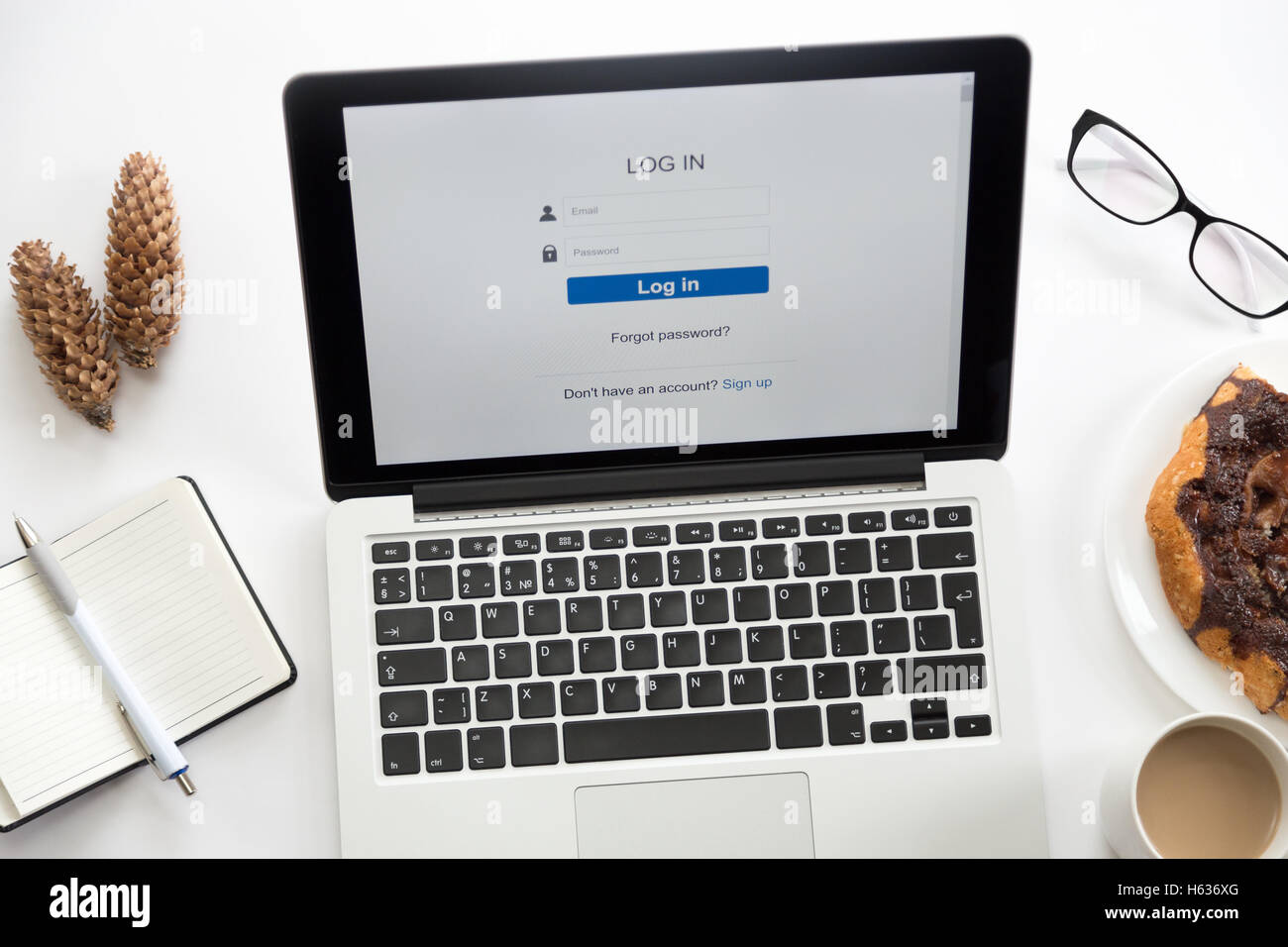 Open laptop with a log in on it, glasses, office supplies Stock Photo ...