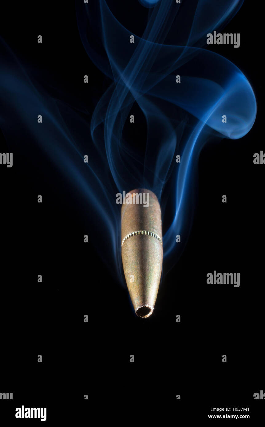 Bullet with a copper coating and smoke coming at the viewer Stock Photo ...