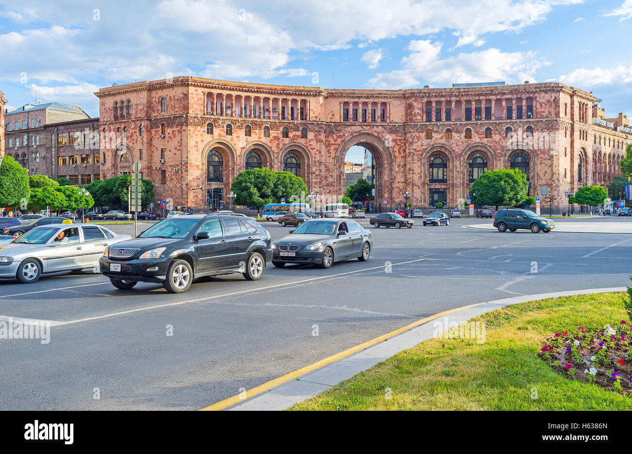 The monumental red stone building with the arched pass in the middle ...