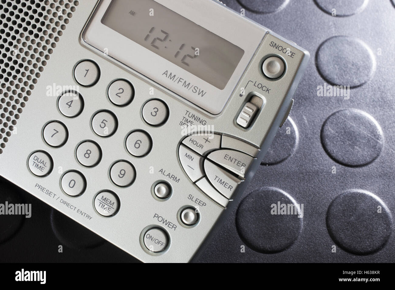 Controls on a battery powered portable radio that has a clock function ...