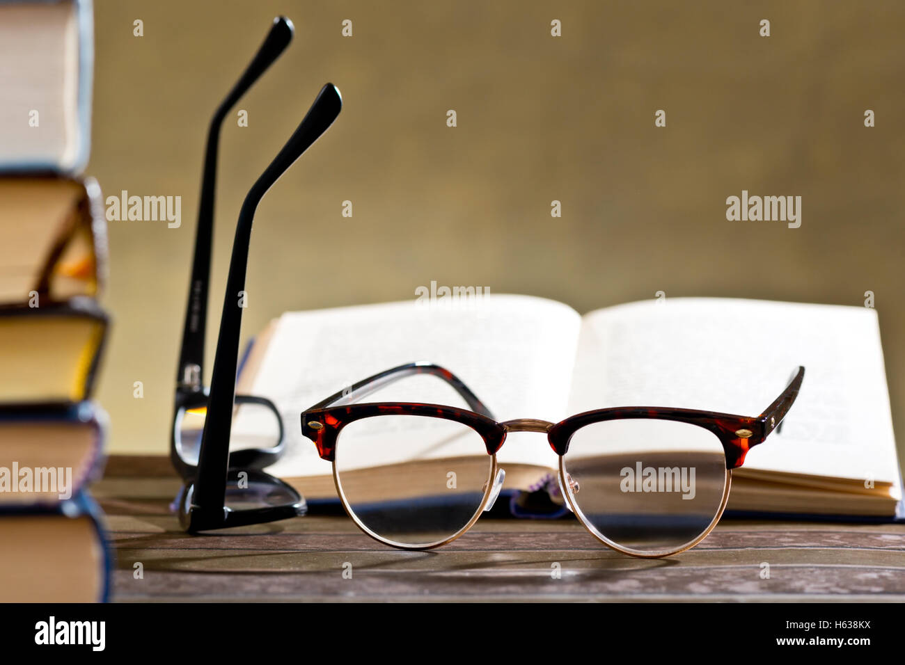 still life with eyeglasses and books on the table Stock Photo - Alamy