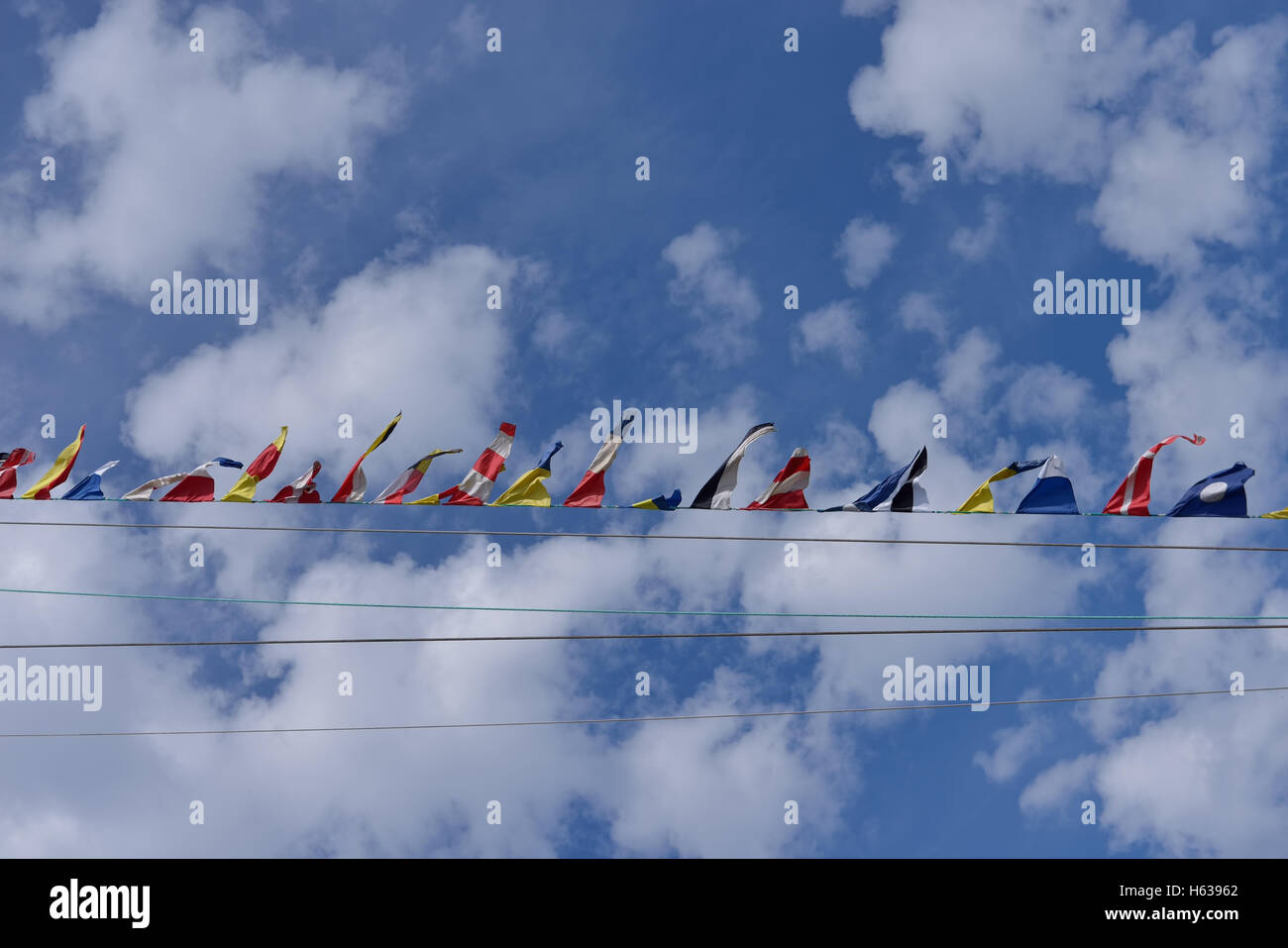 Colorful flags on sail boat for start of departure during last day of ...