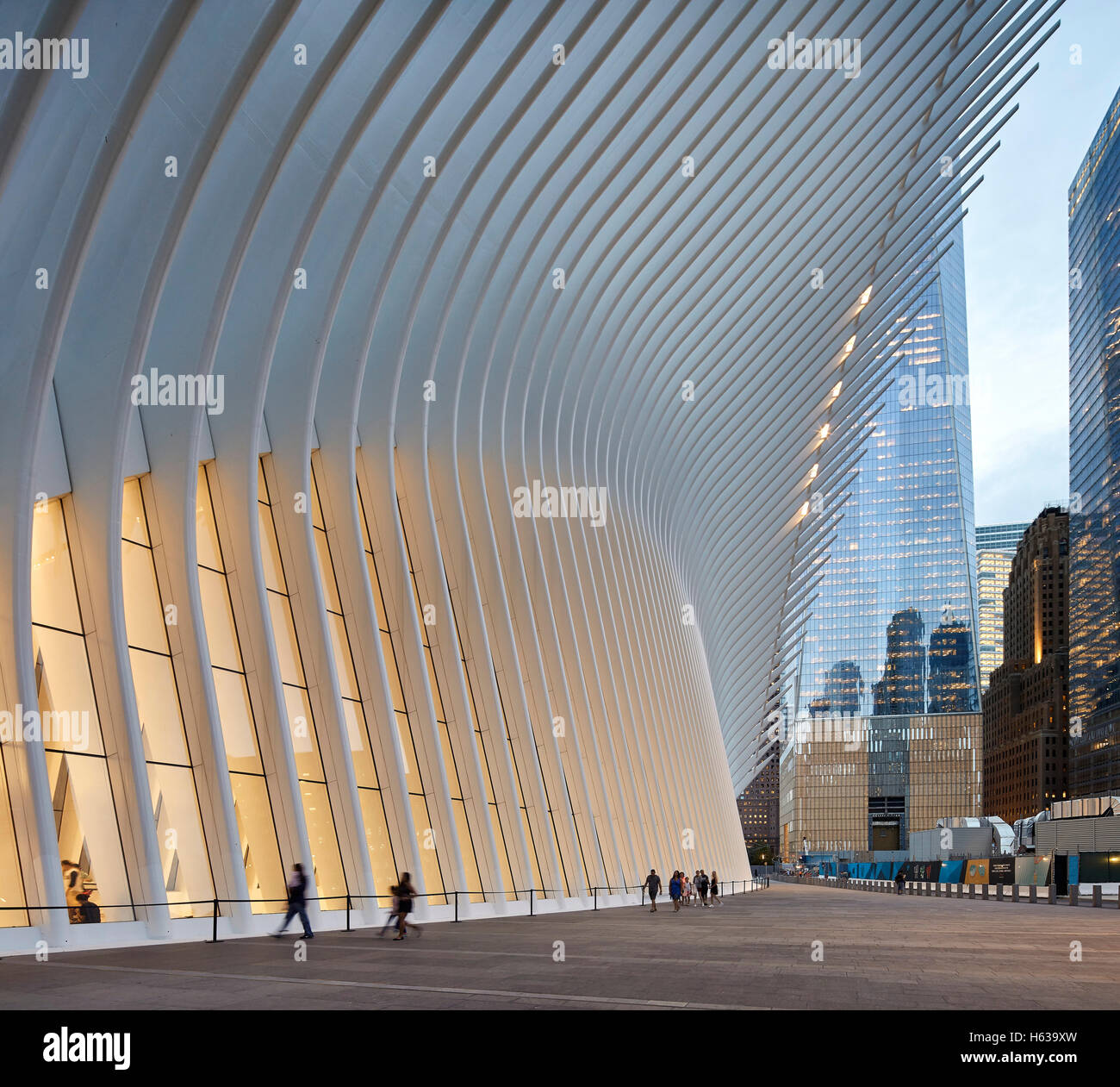 Perspective along steel rib facade at dusk. The Oculus, World Trade ...