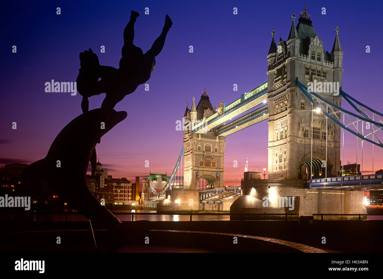 Tower Bridge at dusk with Dolphin and Mermaid statue, London, England ...