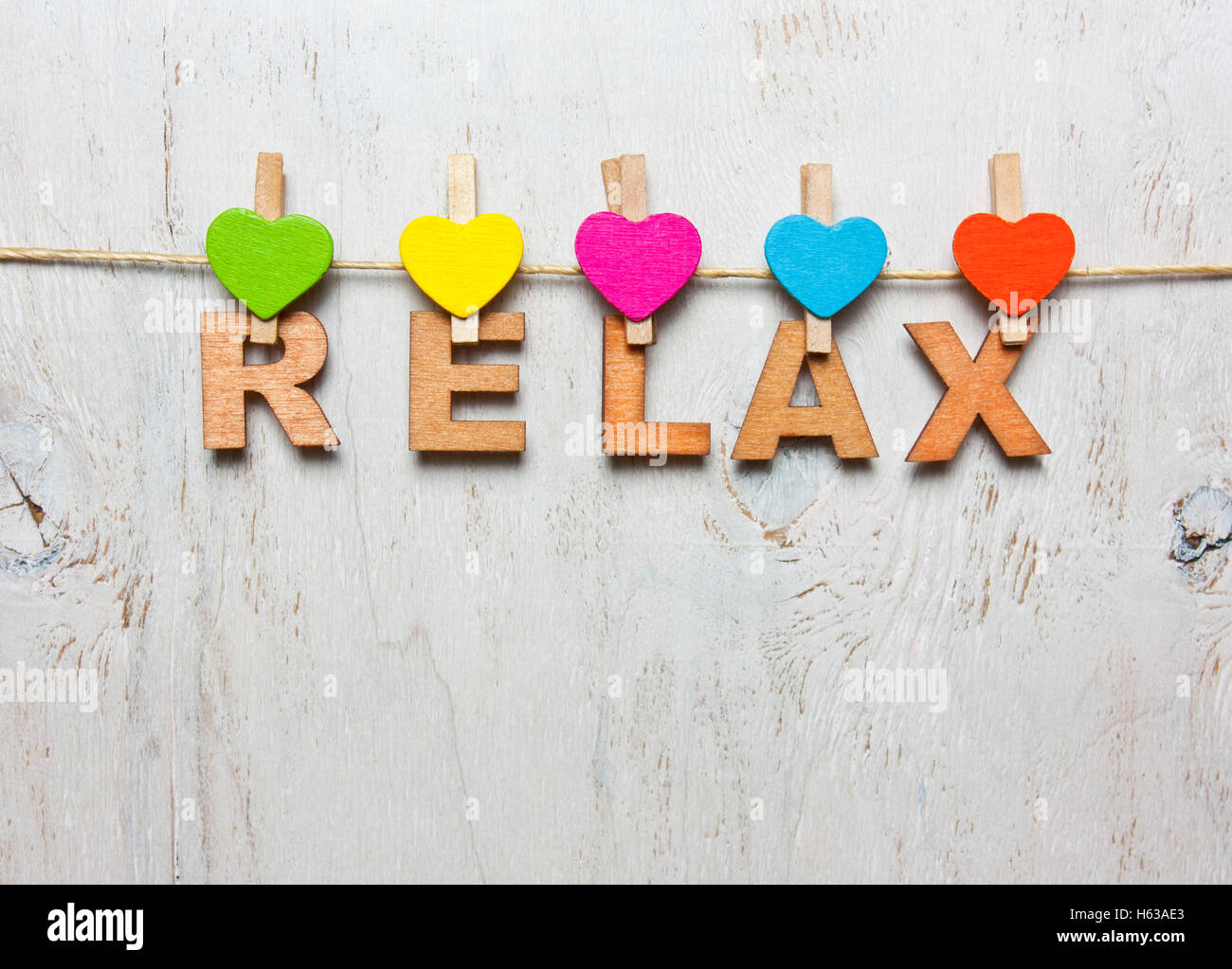 Word relax of wooden letters on a white background with wooden ...