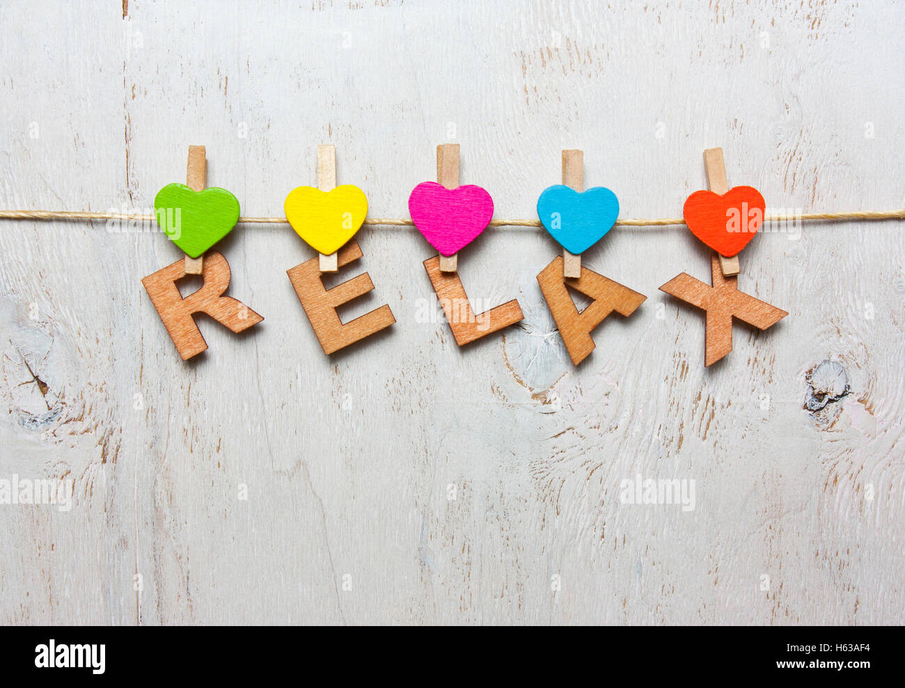 Word relax of wooden letters on a white background with wooden ...