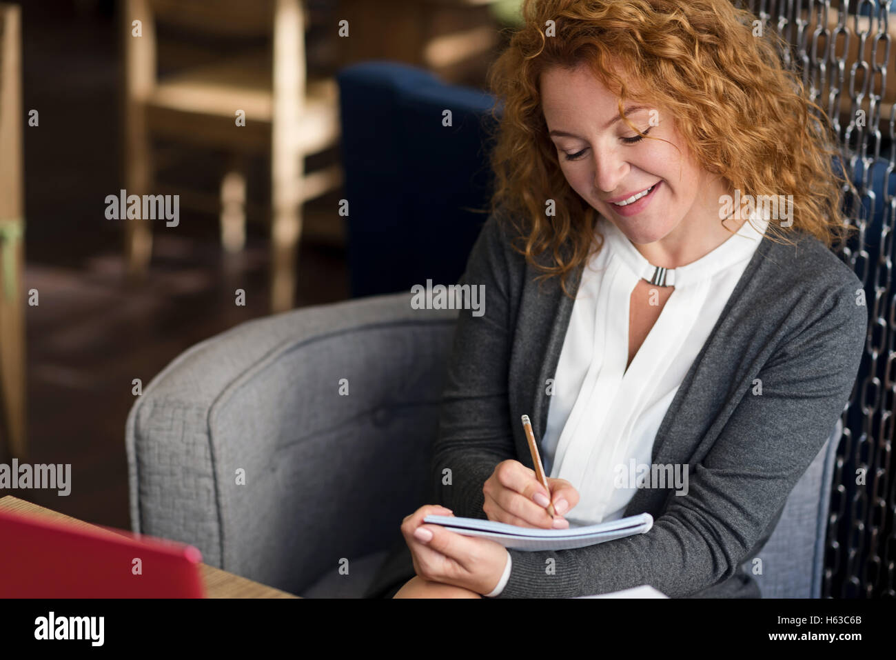 Top view of smiling woman taking notes Stock Photo - Alamy