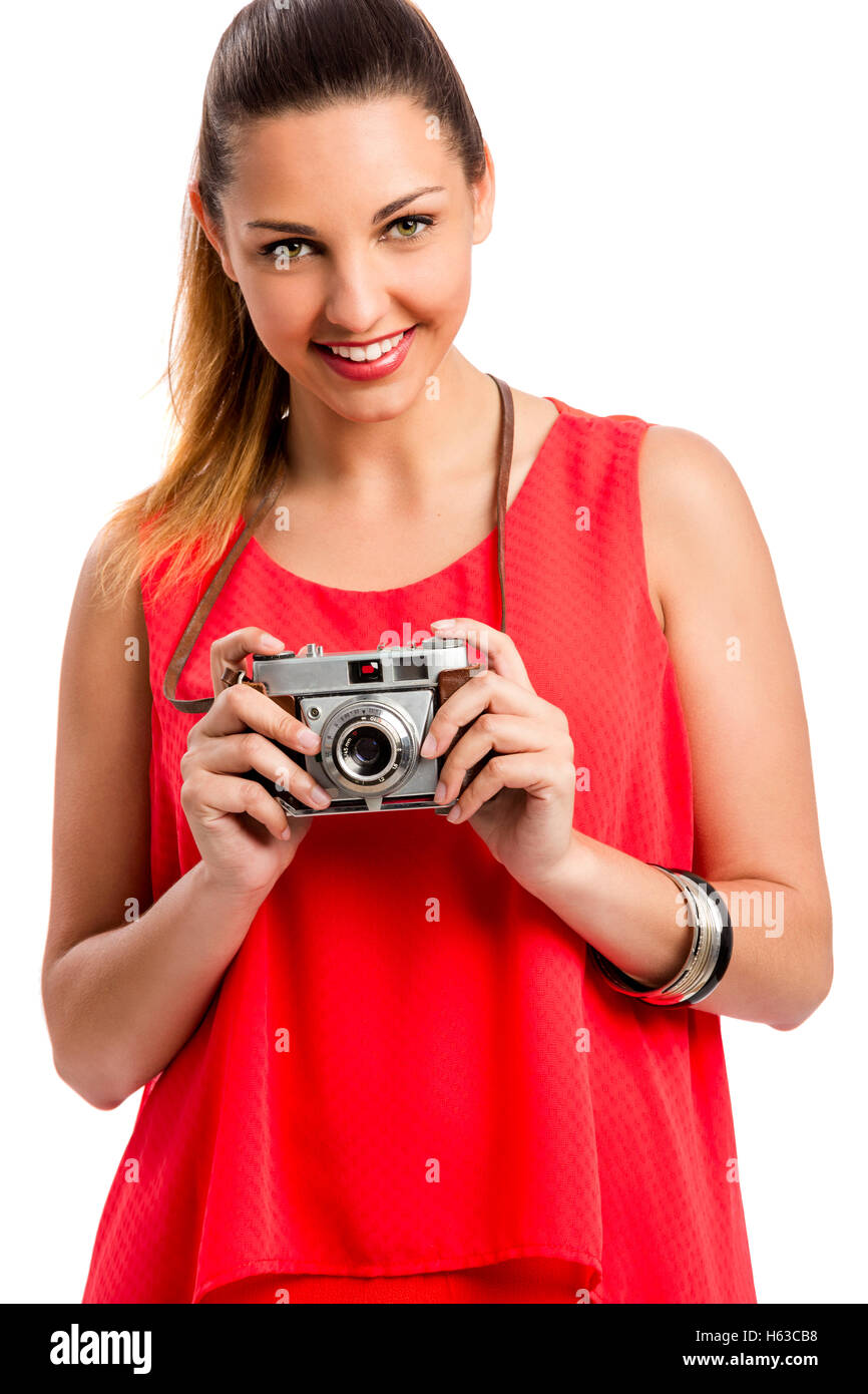 Beautiful woman taking a picture with a vintage camera isolated on a ...