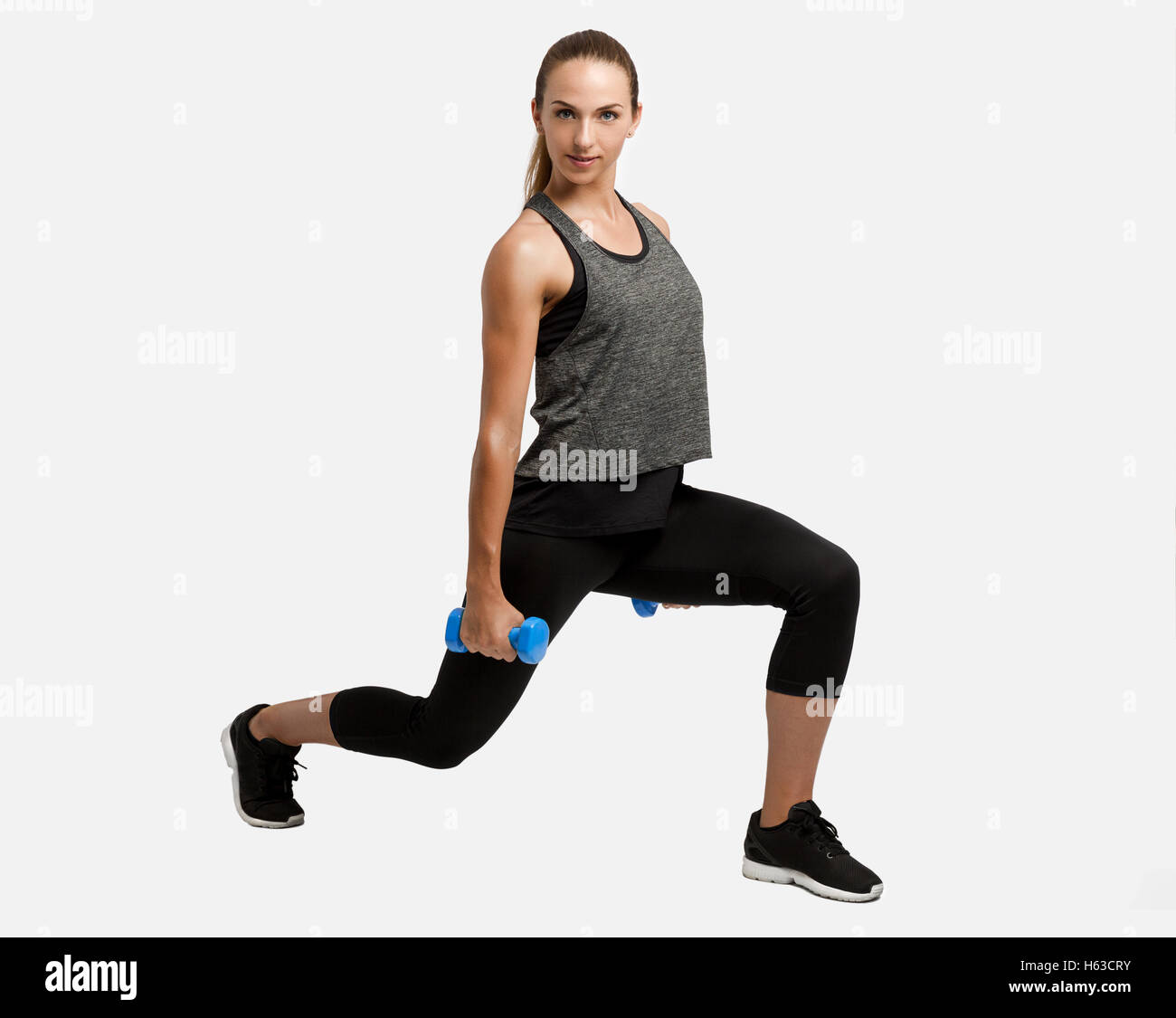Young fitness woman making exercises with dumbbells Stock Photo - Alamy