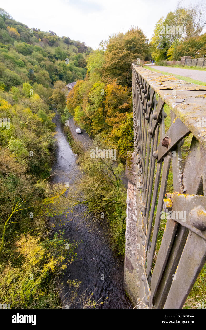 A car passes under the old twin railway bridges at Millers Dale ...
