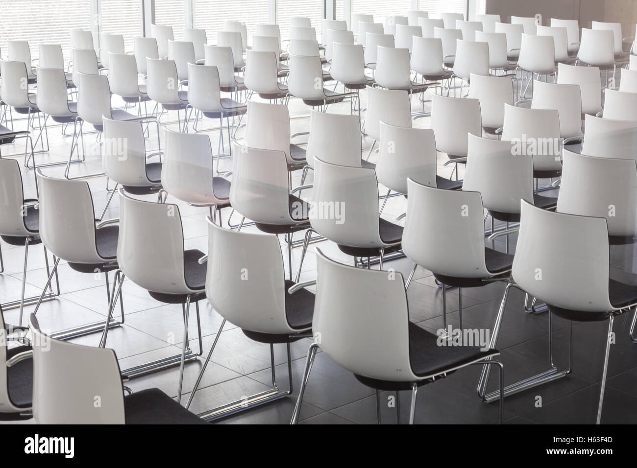 Empty white chairs in contemporary conference hall with Stock Photo - Alamy