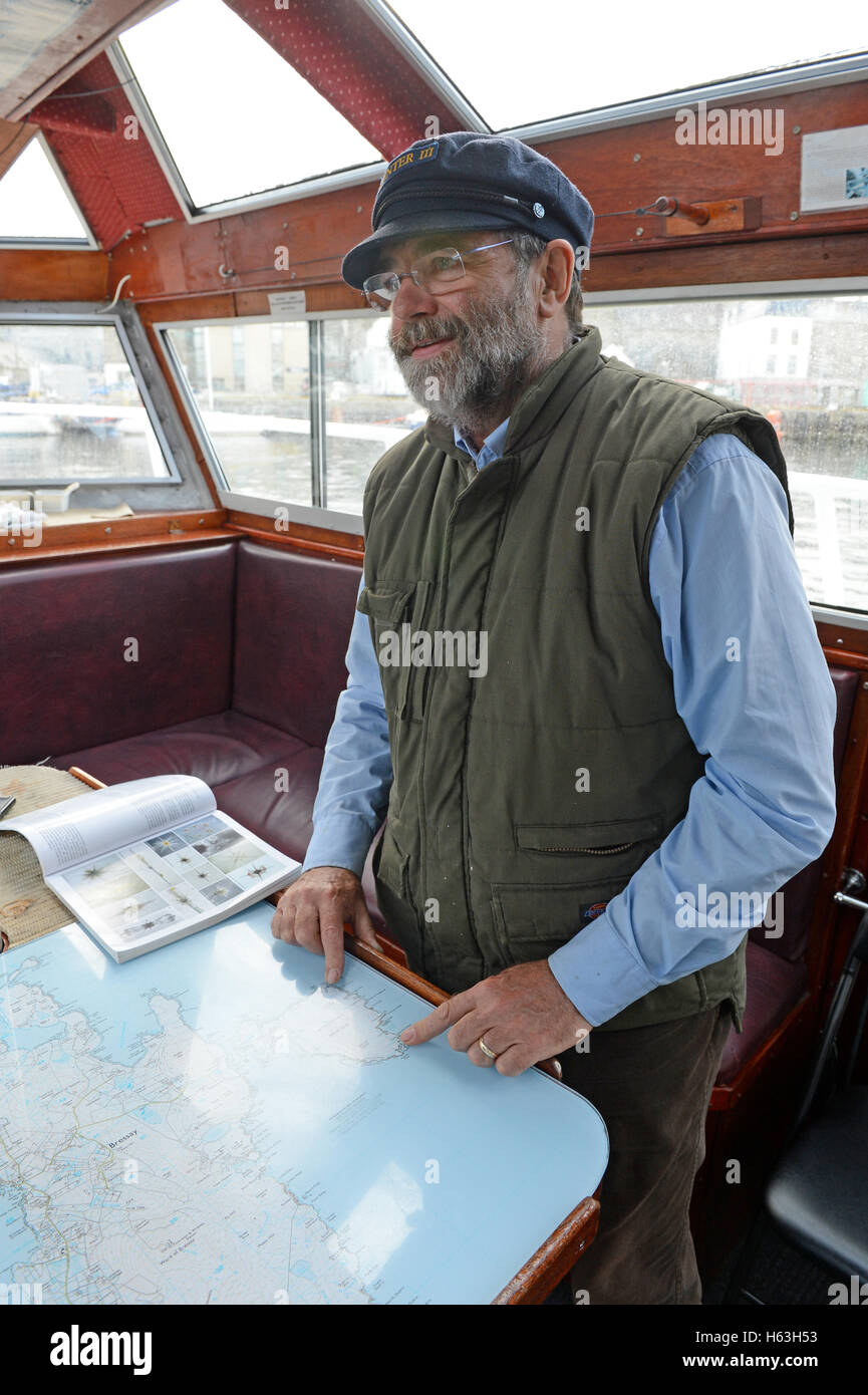 Doctor Jonathan Wills aboard his boat Dunter in Lerwick harbour ...