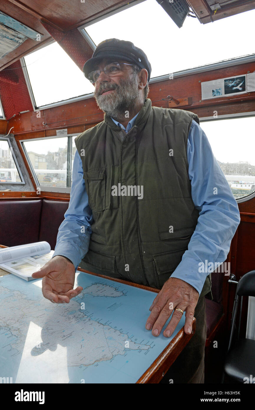 Doctor Jonathan Wills aboard his boat Dunter in Lerwick harbour ...