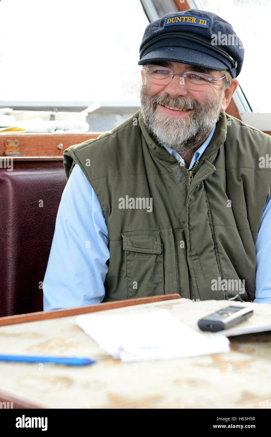 Doctor Jonathan Wills aboard his boat Dunter in Lerwick harbour ...