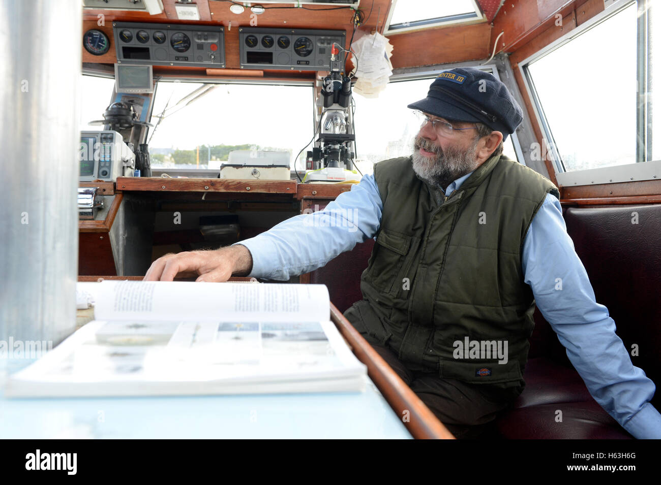 Doctor Jonathan Wills aboard his boat Dunter in Lerwick harbour ...