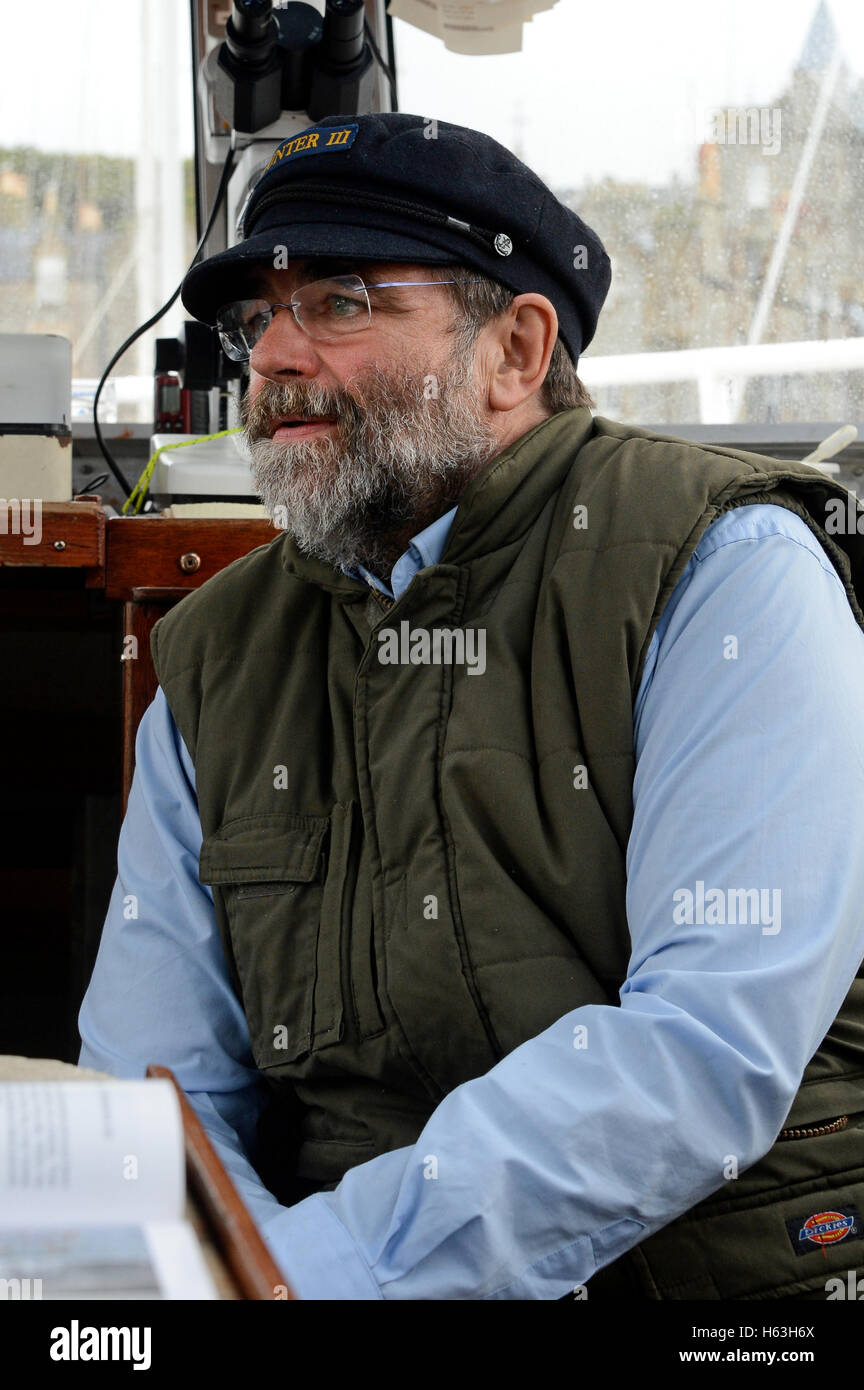 Doctor Jonathan Wills aboard his boat Dunter in Lerwick harbour ...