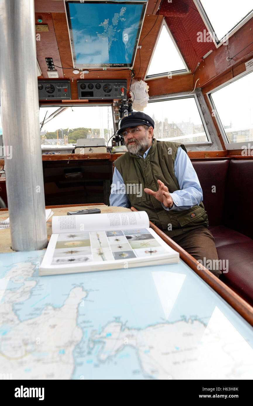 Doctor Jonathan Wills aboard his boat Dunter in Lerwick harbour ...