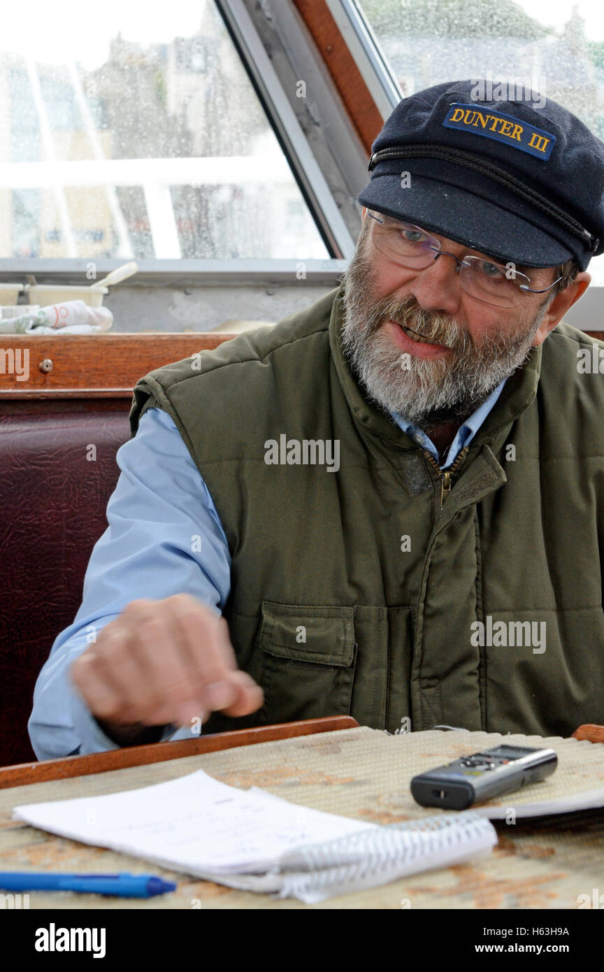 Doctor Jonathan Wills aboard his boat Dunter in Lerwick harbour ...