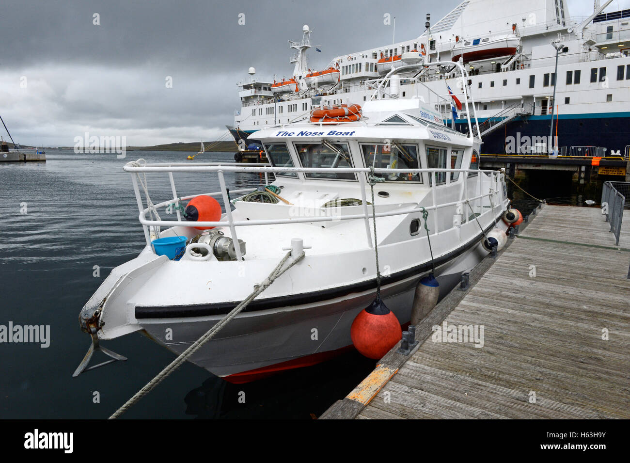 Doctor Jonathan Wills aboard his boat Dunter in Lerwick harbour ...