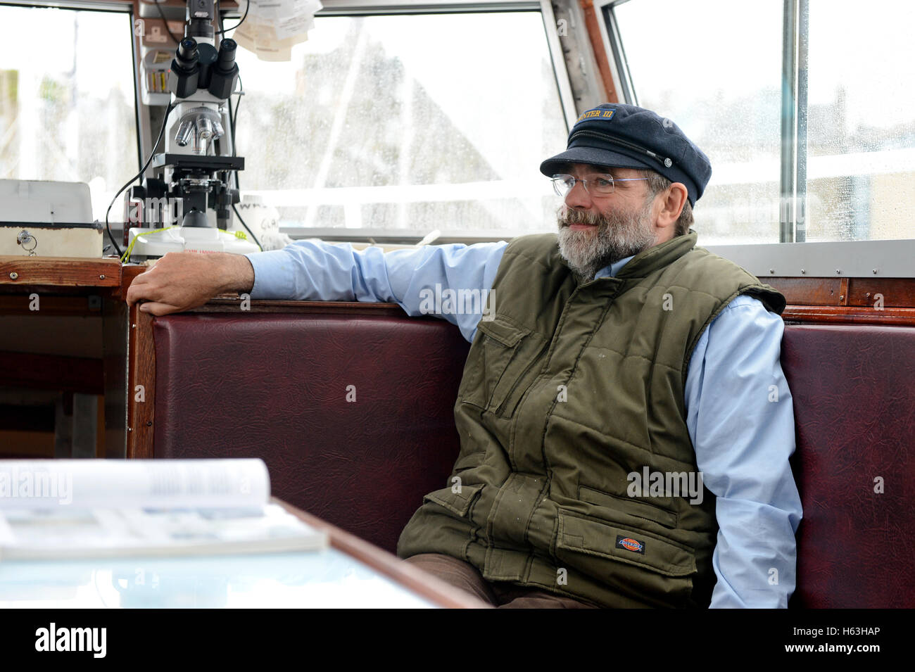 Doctor Jonathan Wills aboard his boat Dunter in Lerwick harbour ...